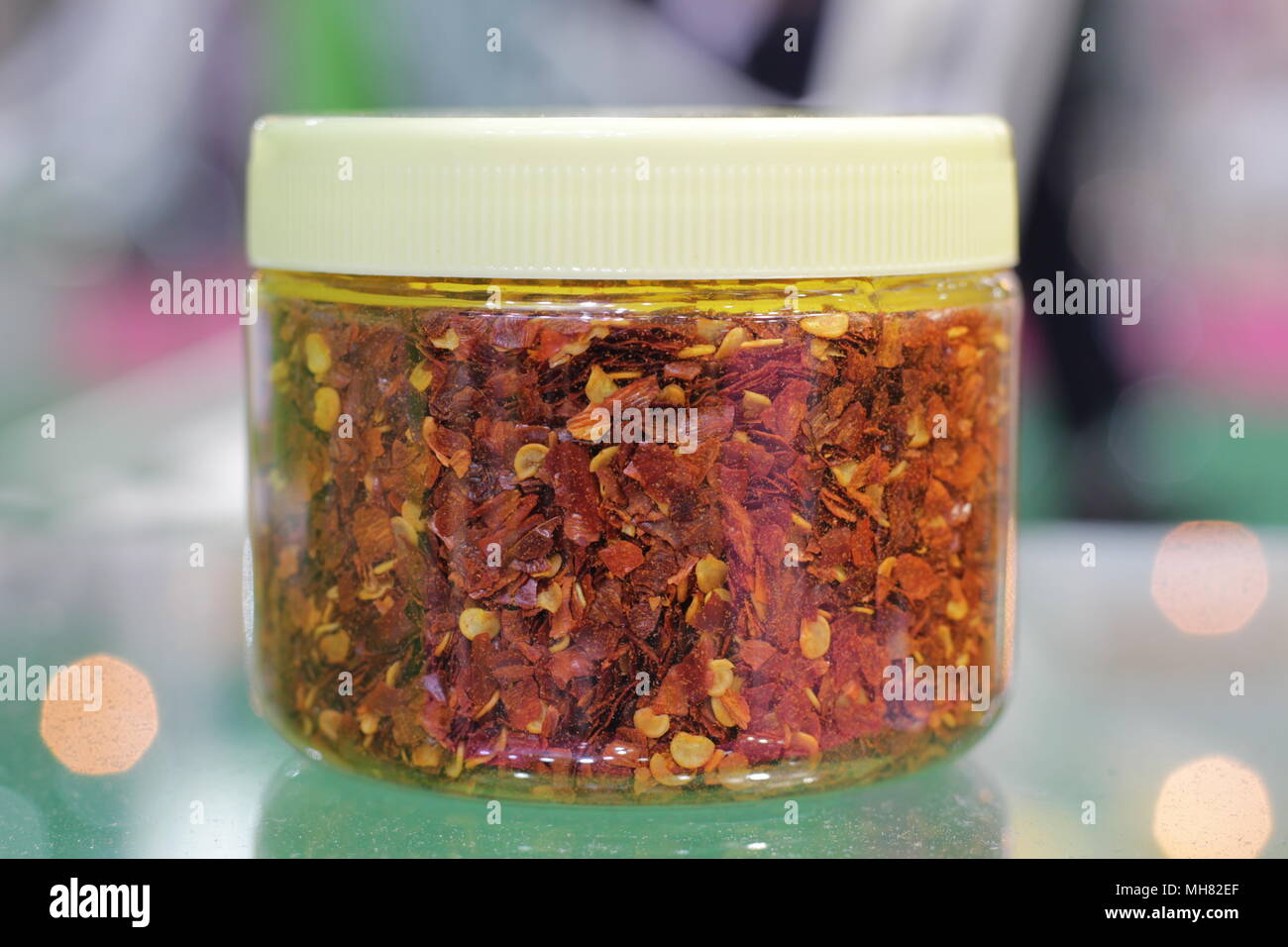 Red Ground chilli in bottle ; close up Stock Photo - Alamy