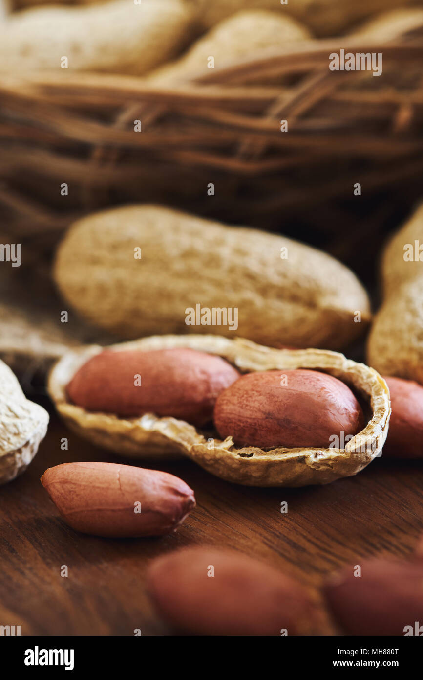 Dry roasted peanuts (salted, in shell) on wooden background Stock Photo ...