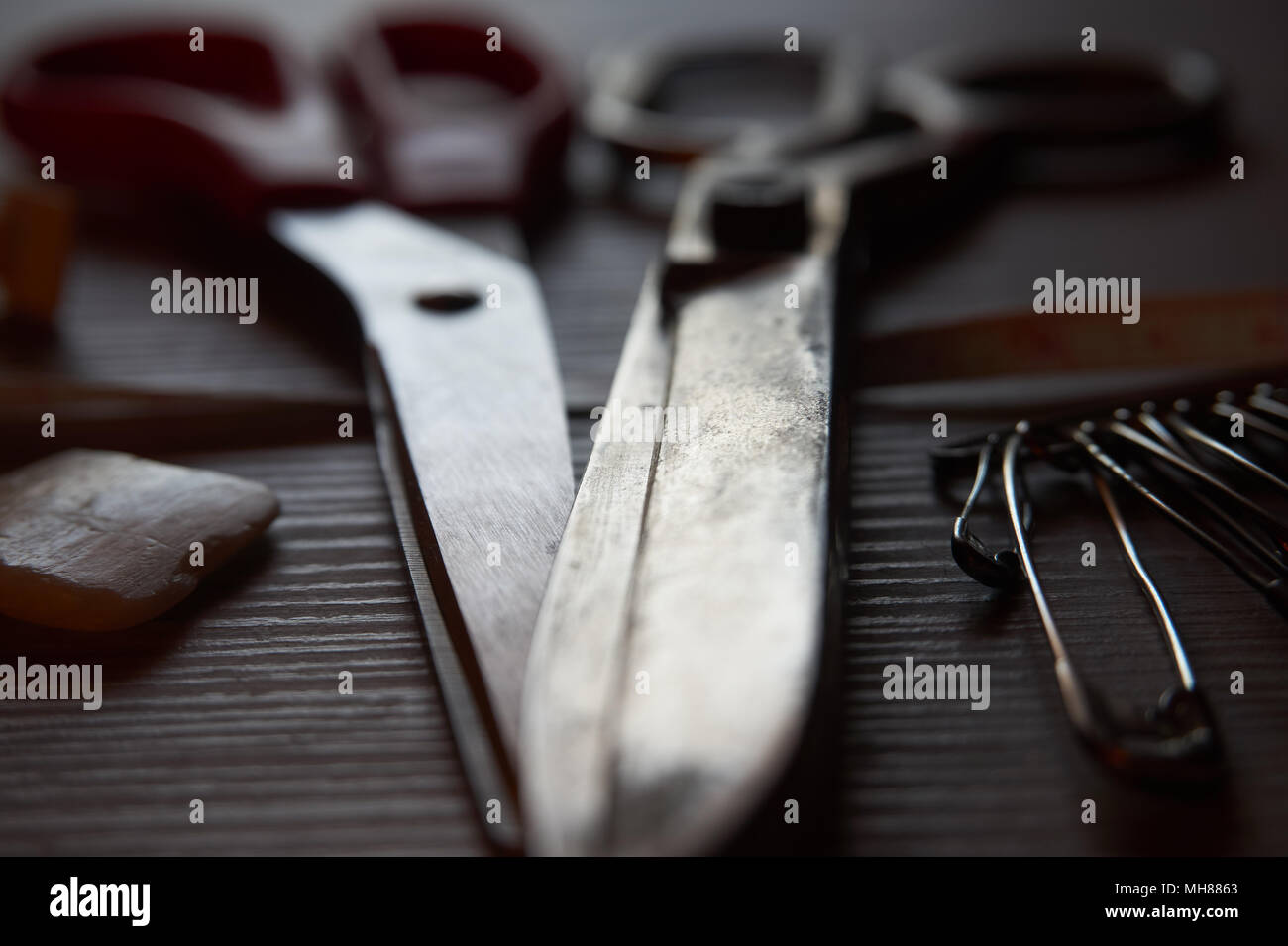 Old metal scissors, chalk, safety pins and tailor measure tape on grey ...