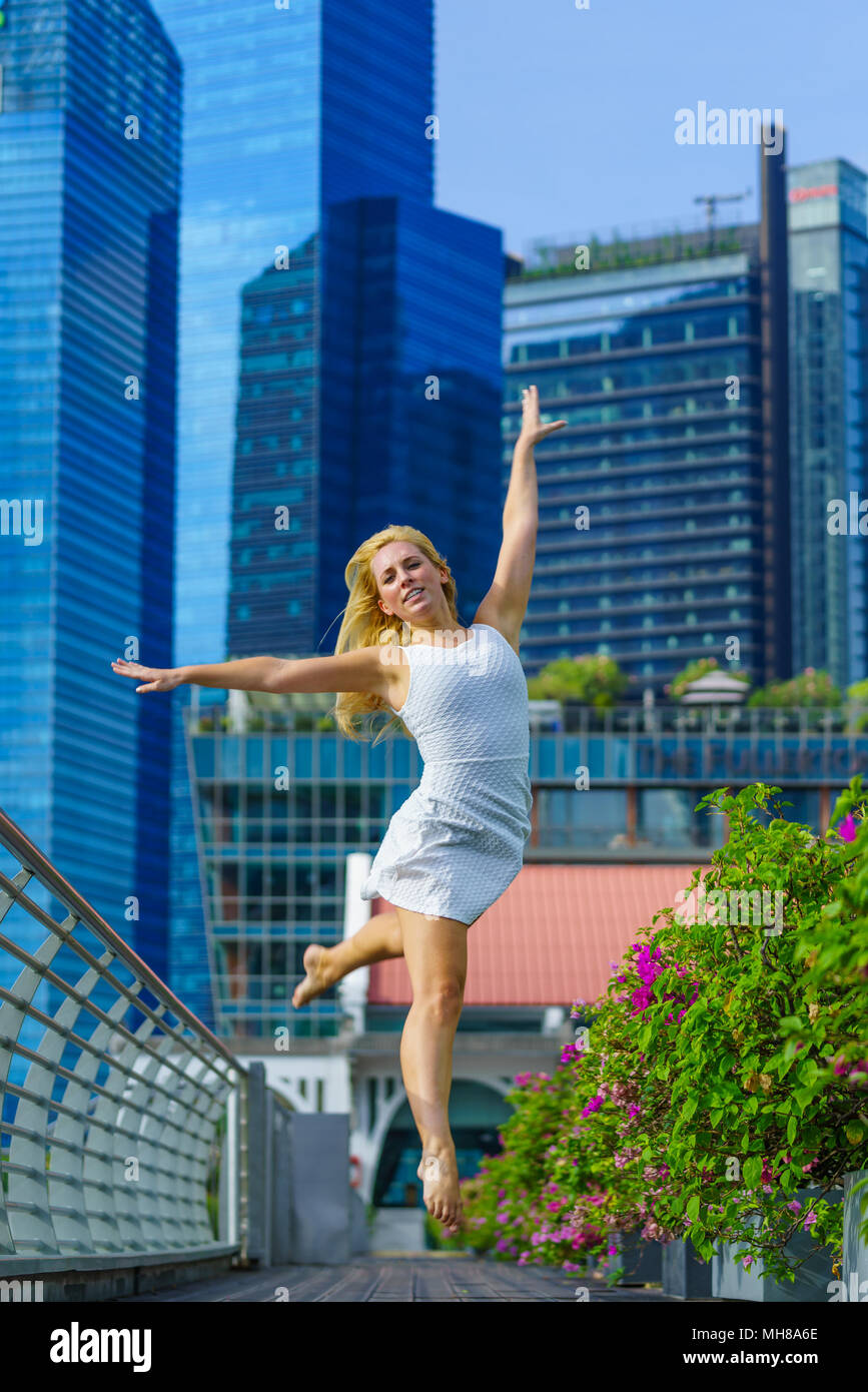 Elegant ballet dancer woman dancing ballet in the city of Singapore ...