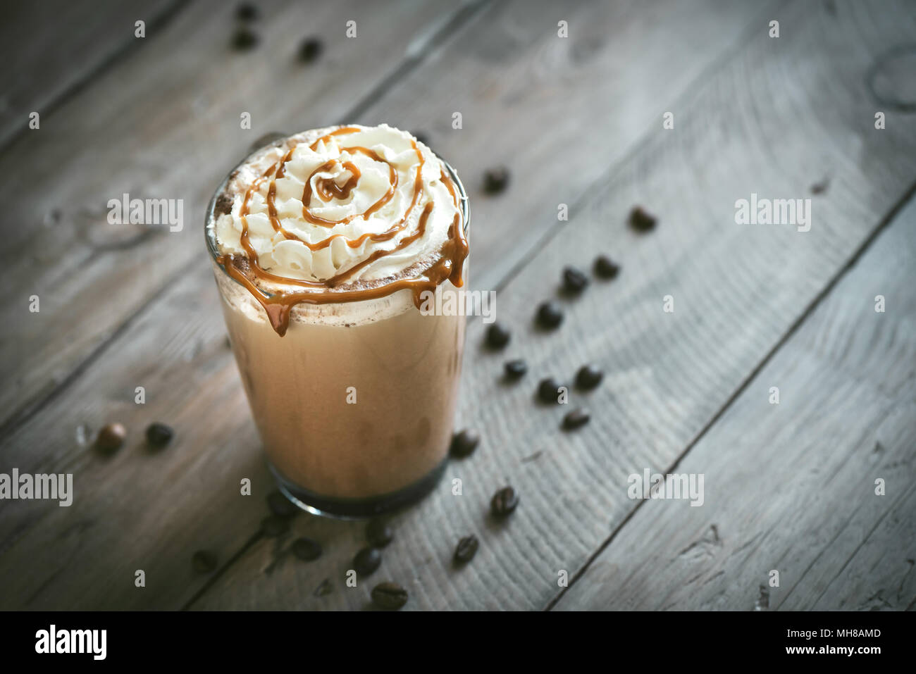 Cold Frappe Coffee (frappuccino) with whipped cream and caramel on dark ...
