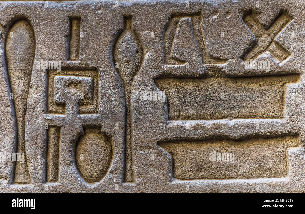 Egyptian hieroglyphs on the wall in a temple Stock Photo - Alamy
