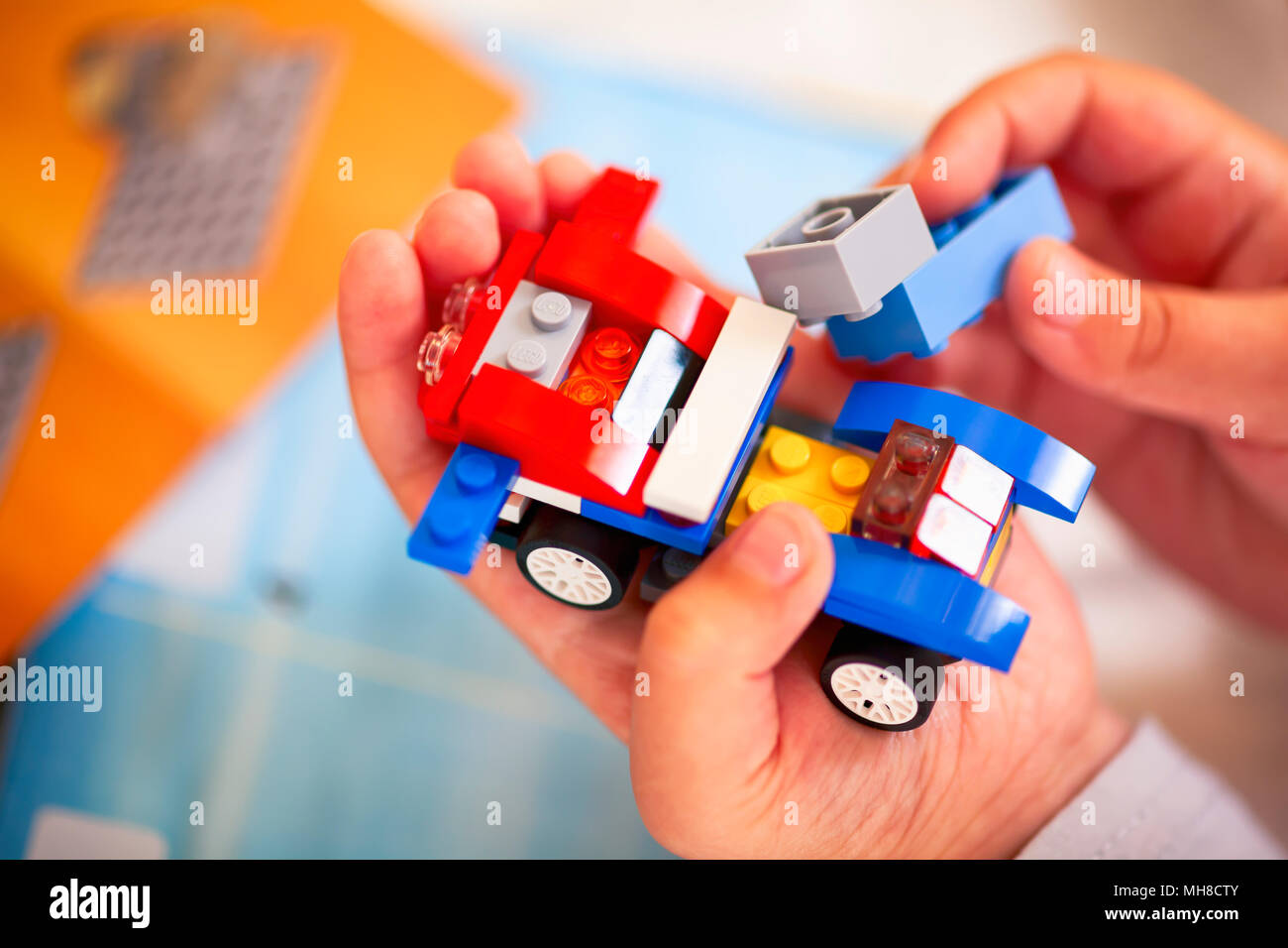 Tambov, Russian Federation - December 19, 2013 Child building Lego car ...