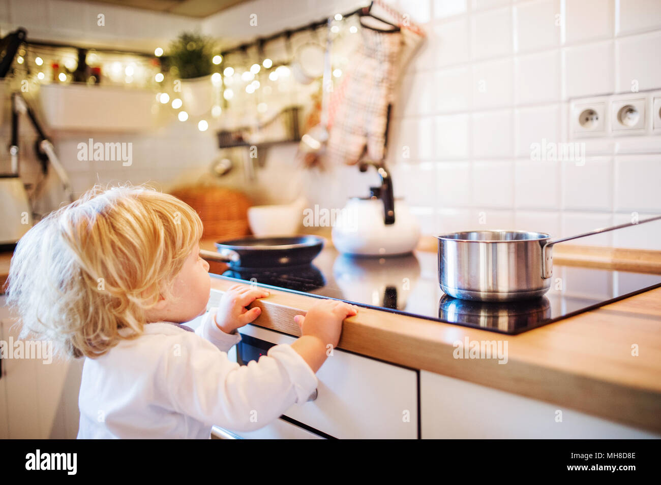 Toddler boy child reaching dangerous hi-res stock photography and ...