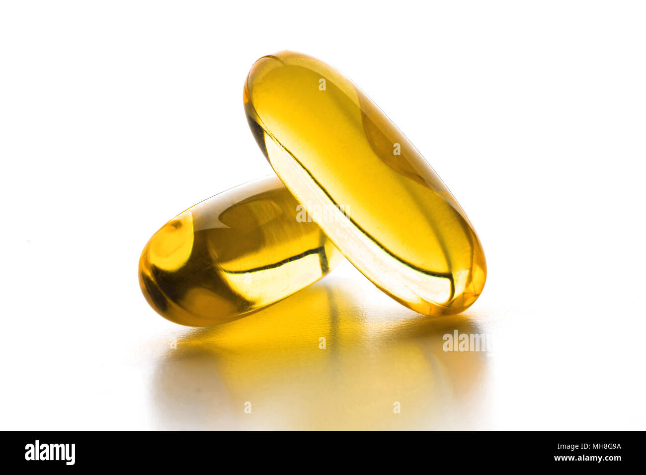 Capsules of fish oil isolated on white background Stock Photo - Alamy