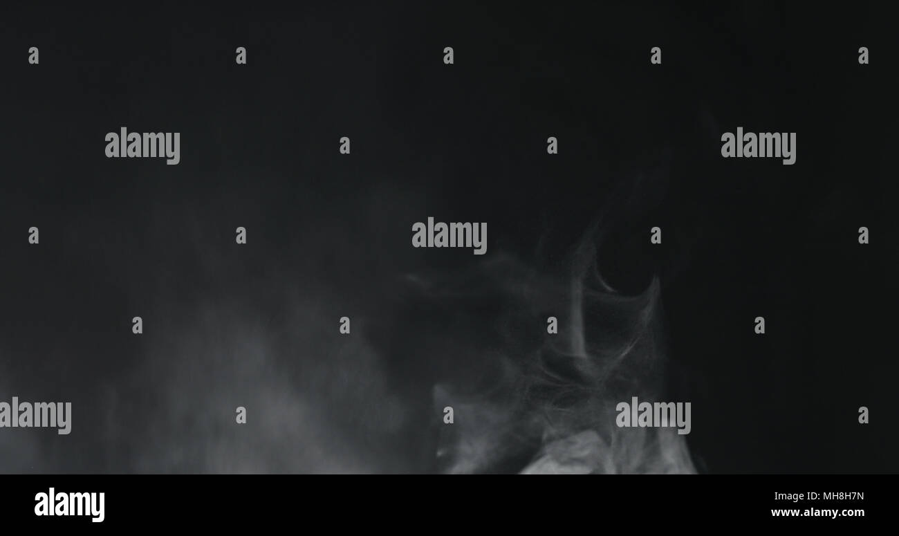 vapor steam rising over black background Stock Photo - Alamy