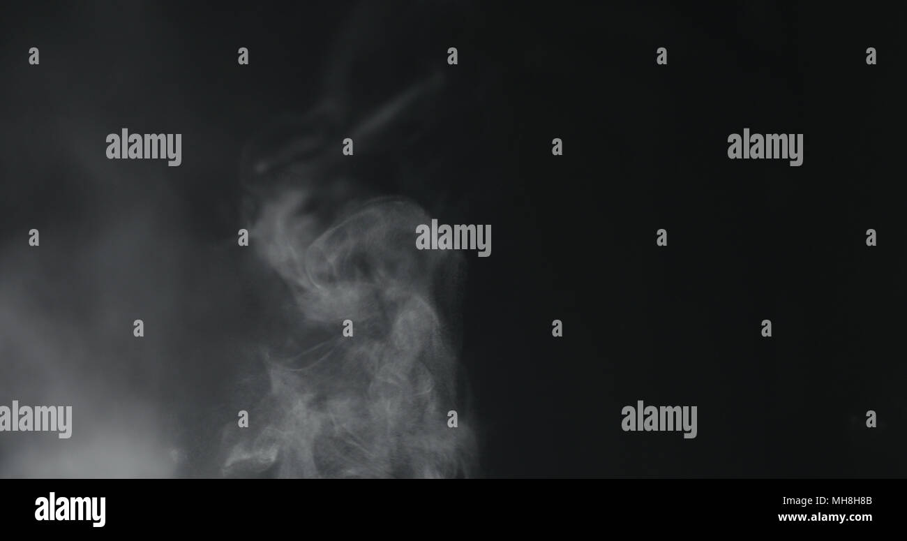 vapor steam rising over black background Stock Photo - Alamy