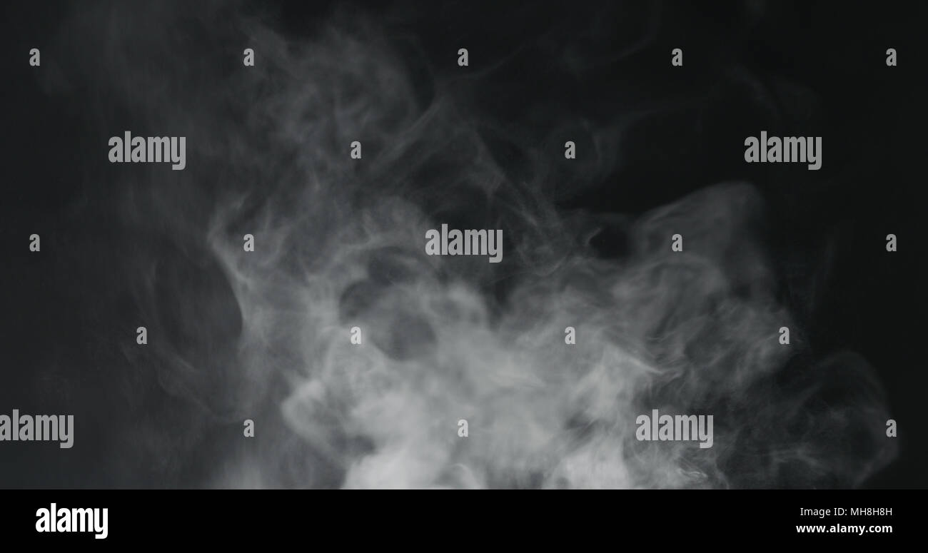 vapor steam rising over black background Stock Photo - Alamy