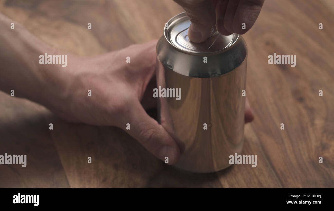 man hand opening can with soda drink Stock Photo - Alamy