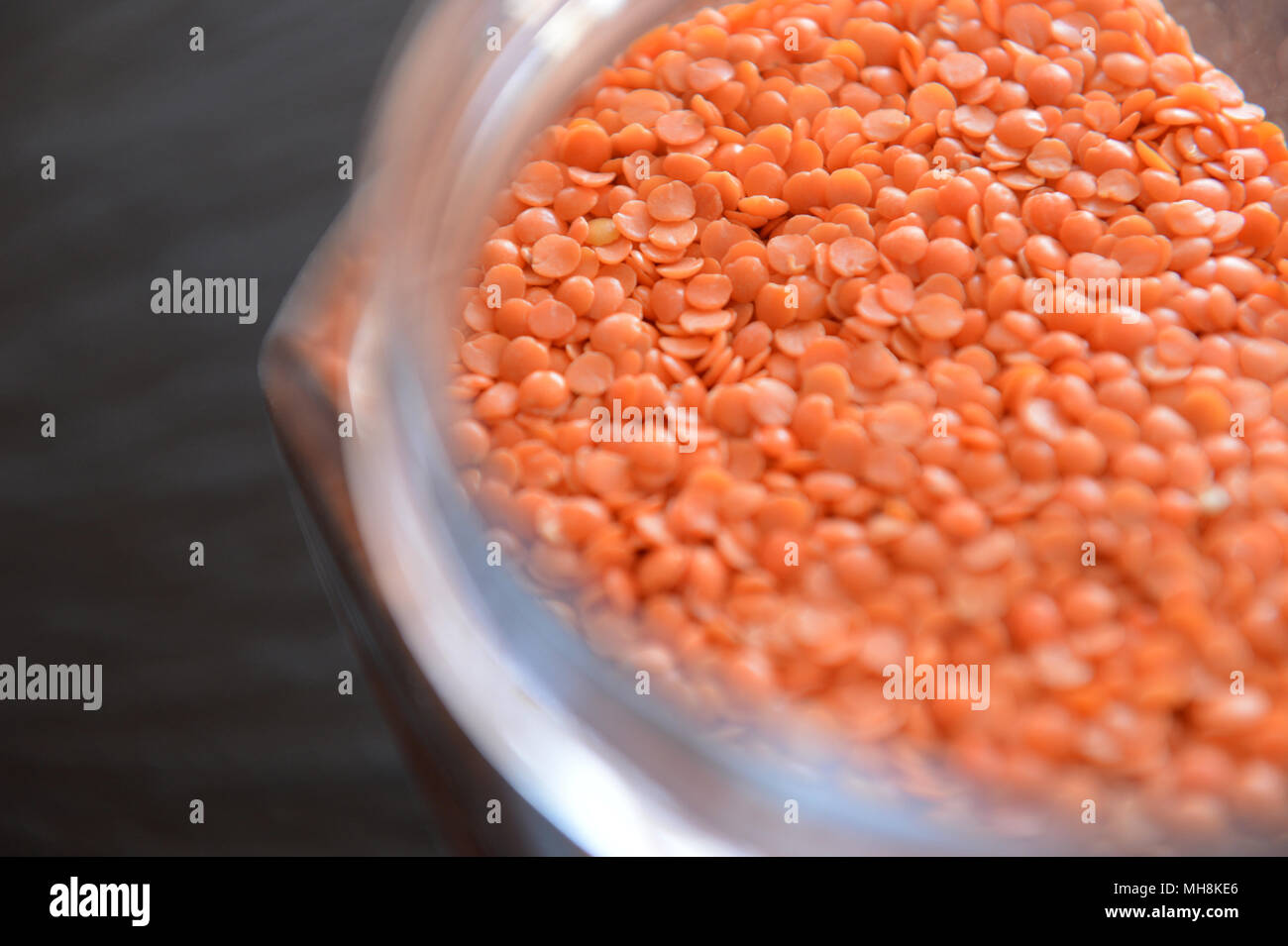 Red lentils in a storage jar Stock Photo - Alamy