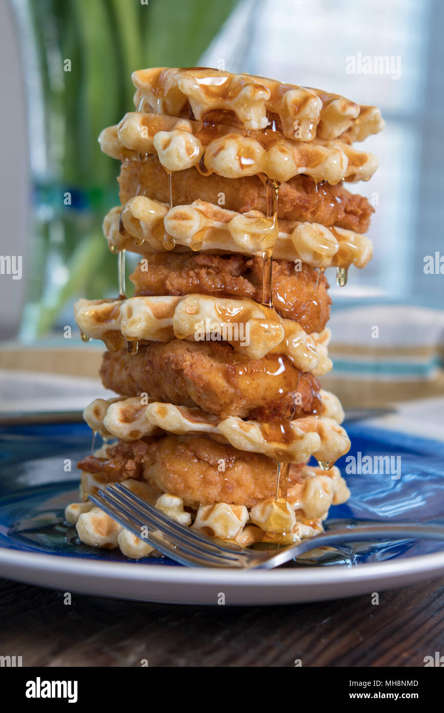 Ready to Eat Chicken and Waffle Tower on blue plate Stock Photo - Alamy