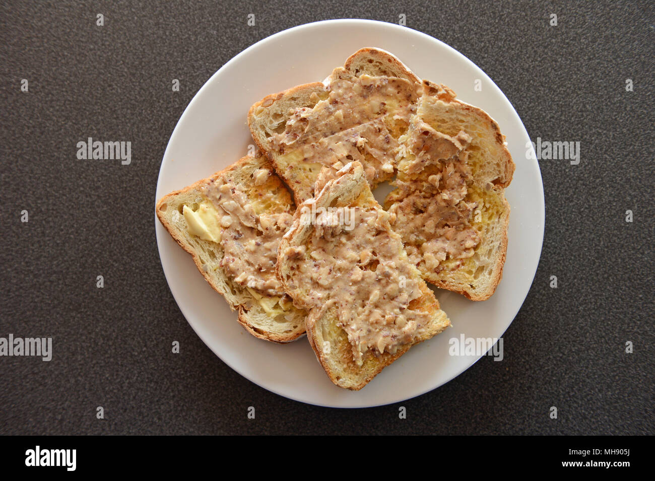 Crunchy peanut butter on buttery toast Stock Photo - Alamy