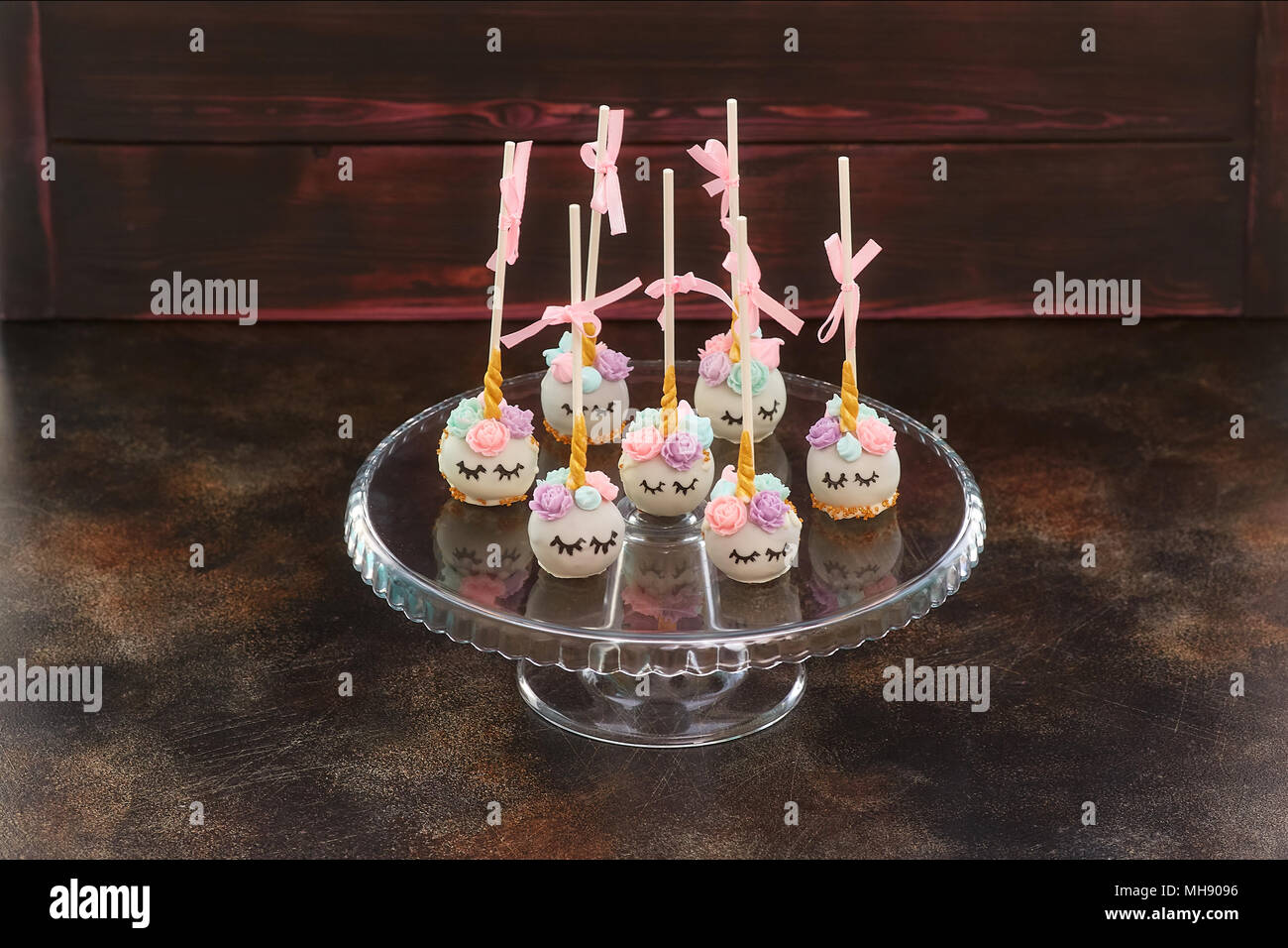 Colorful sweet cake pops with faces on dark wooden background Stock ...
