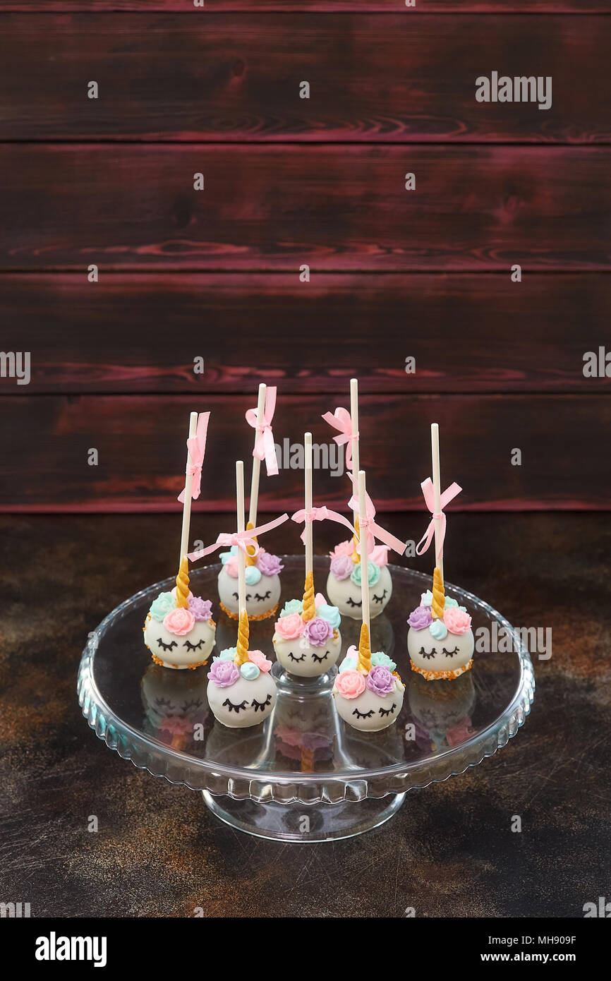 Colorful sweet cake pops with faces on dark wooden background Stock ...