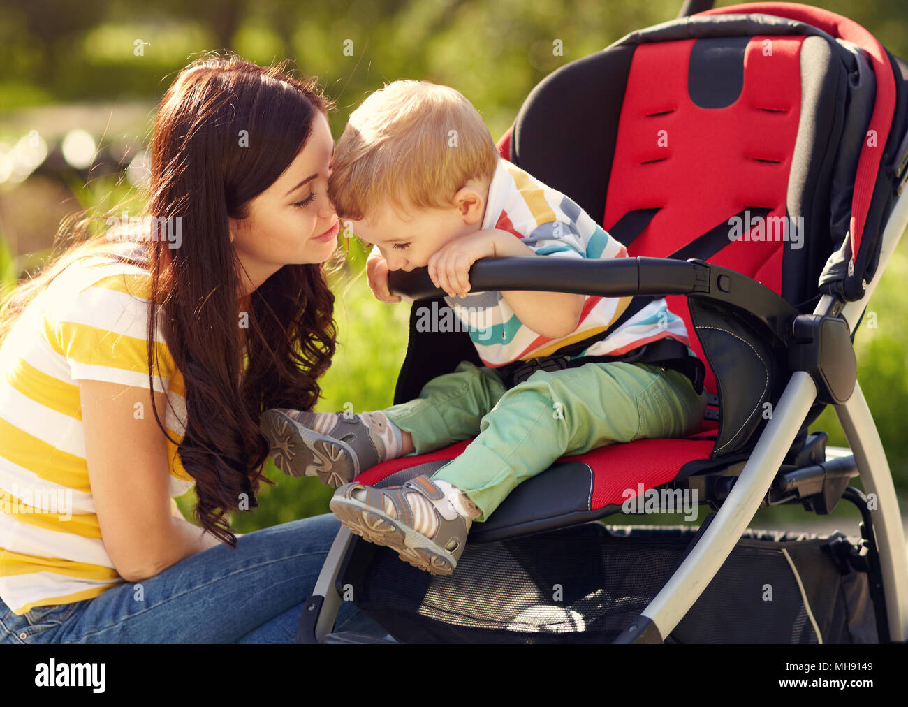 baby sitting in stroller and mom Stock Photo - Alamy