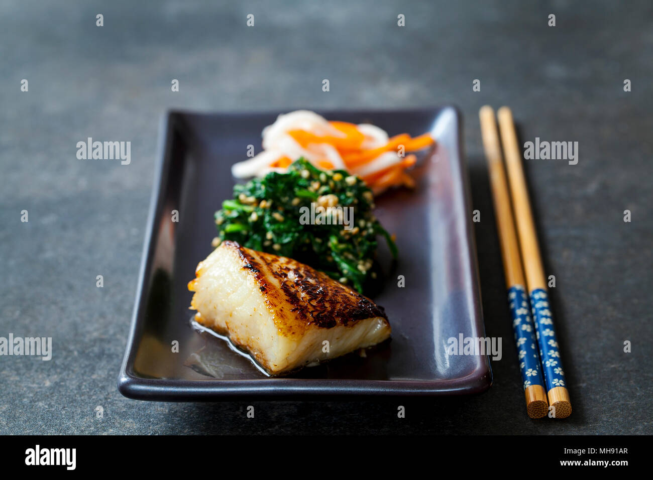 Miso marinated black cod with Japanese spinach salad gomaae Stock Photo ...