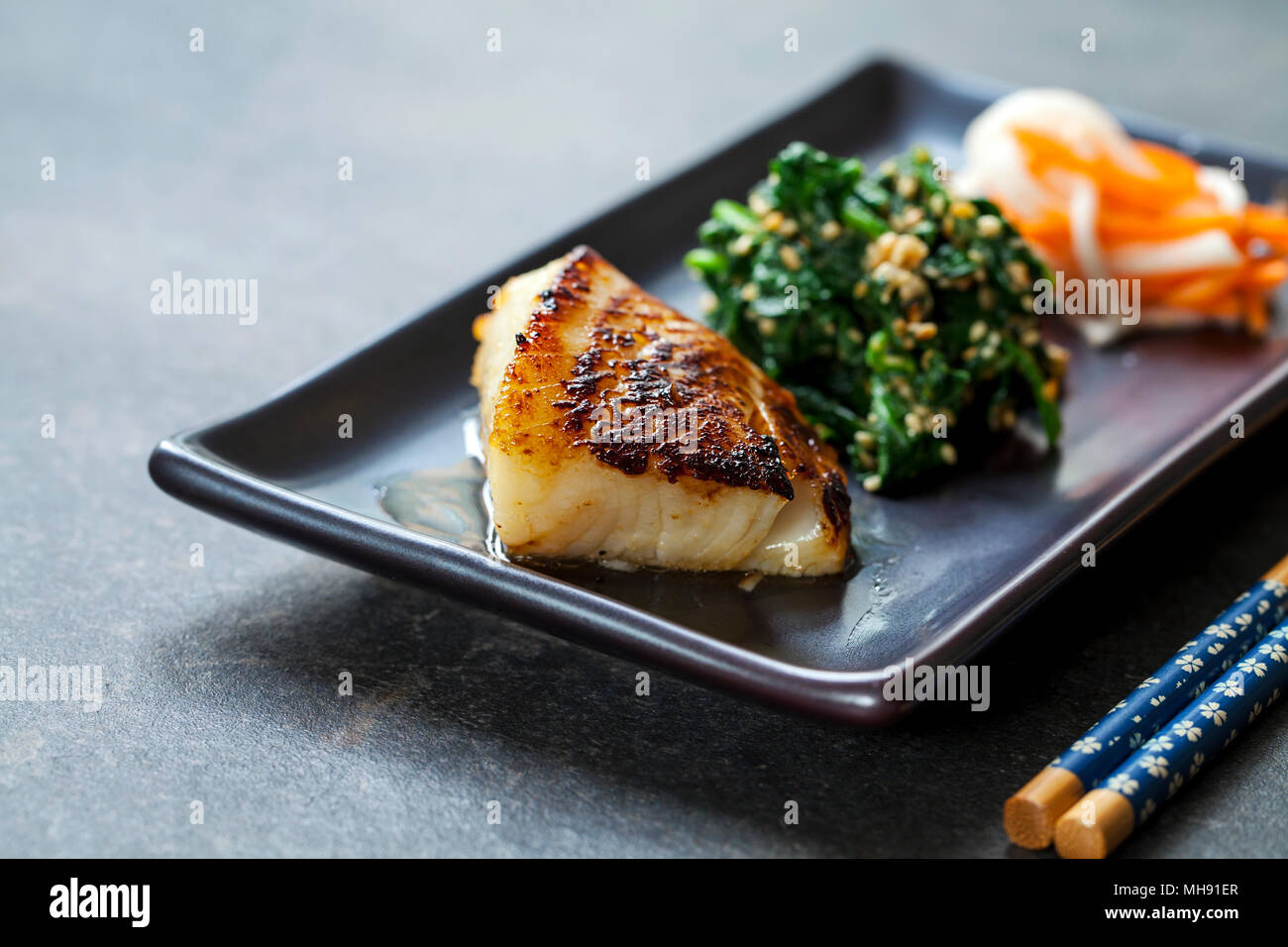 Miso marinated black cod with Japanese spinach salad gomaae Stock Photo ...