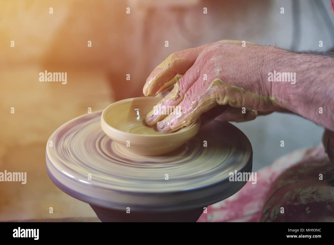 Creating a jar or vase of white clay close-up. Man hands, pottery ...