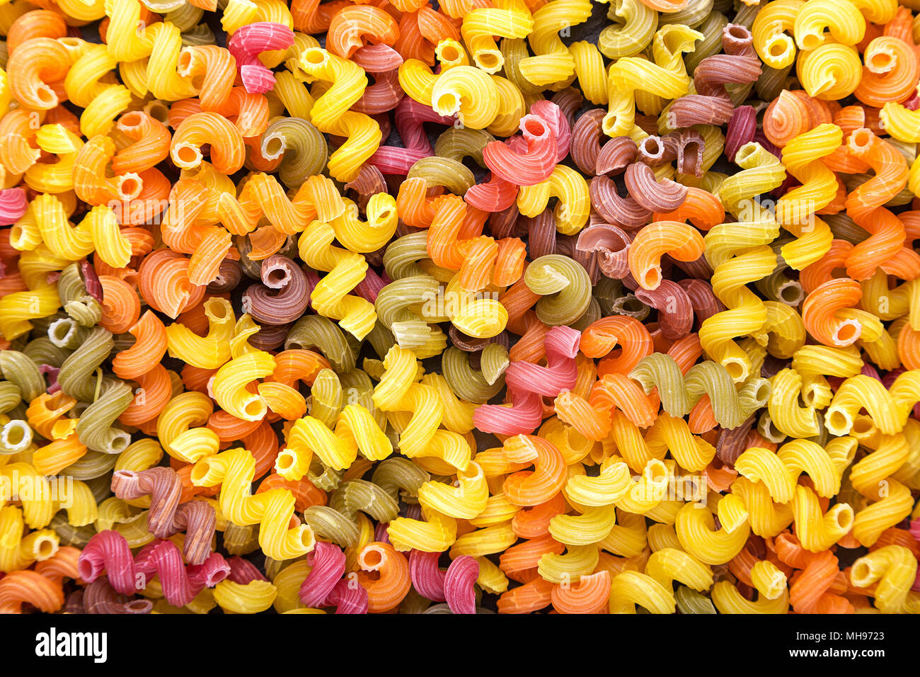 a scattered colored pasta, not cooked, background for recipe Stock ...