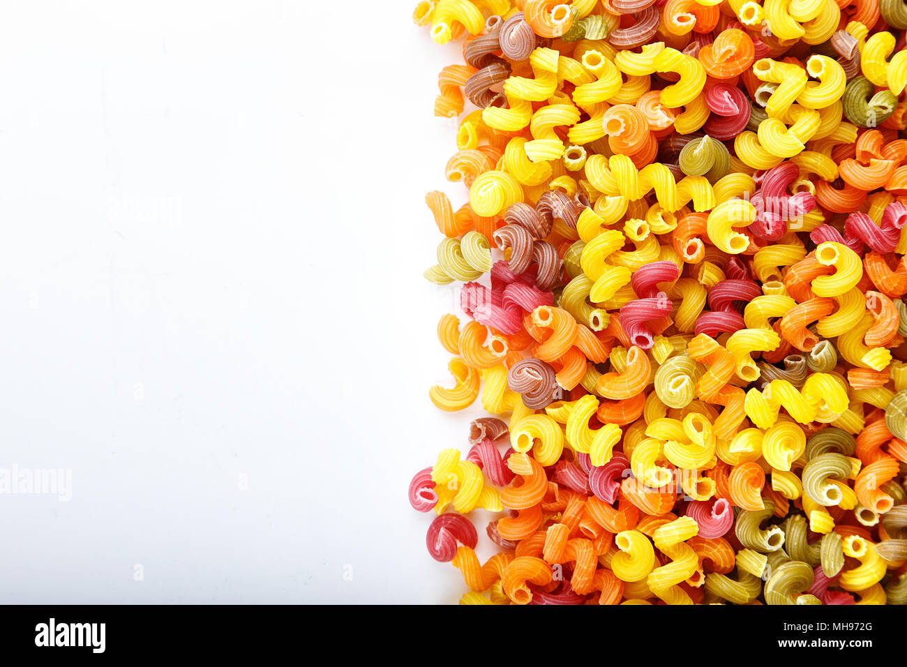 a scattered colored pasta, not cooked, background for recipe Stock ...