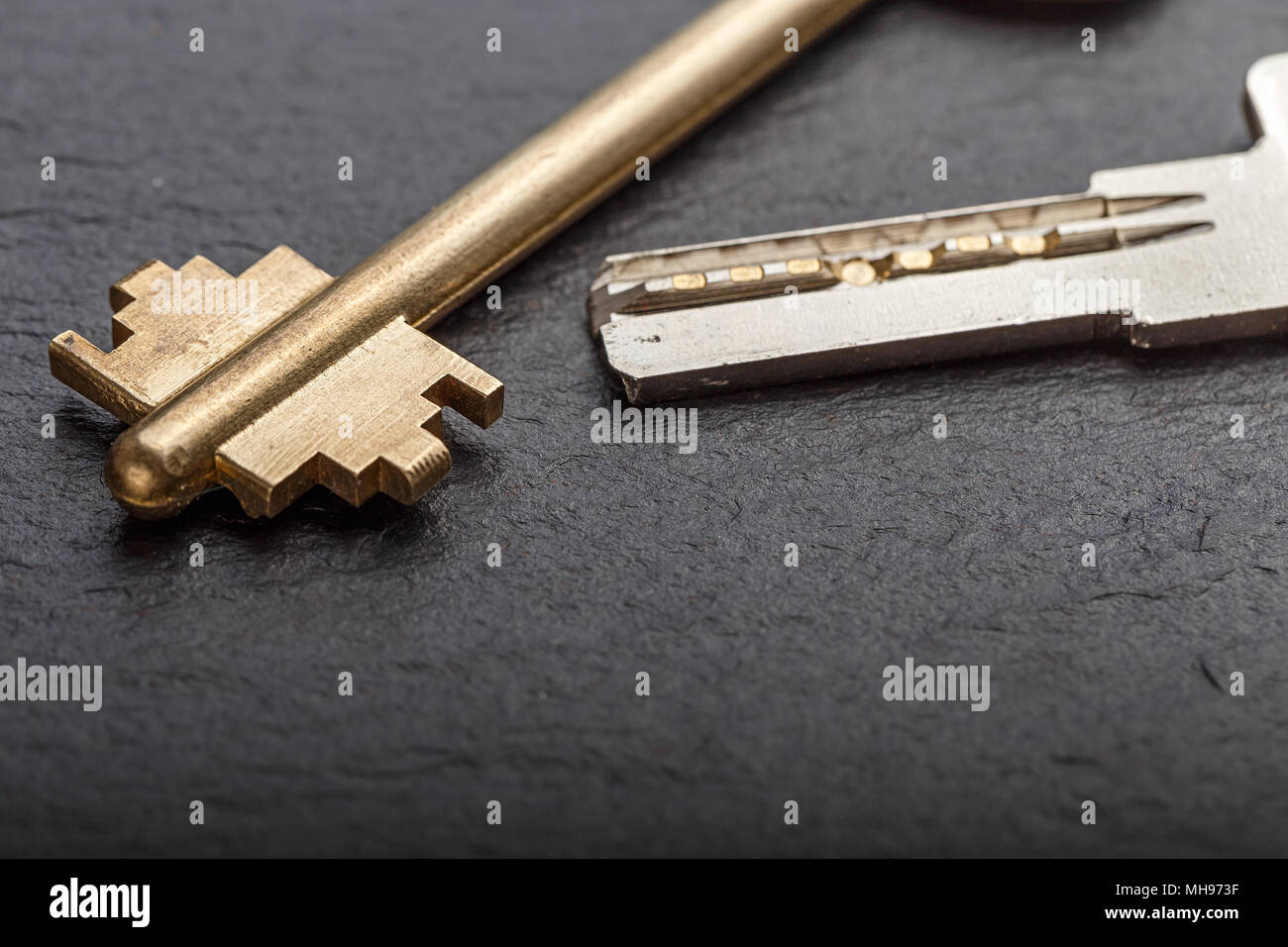 Bunch of golden metal keys on a black background, horizontal photo ...