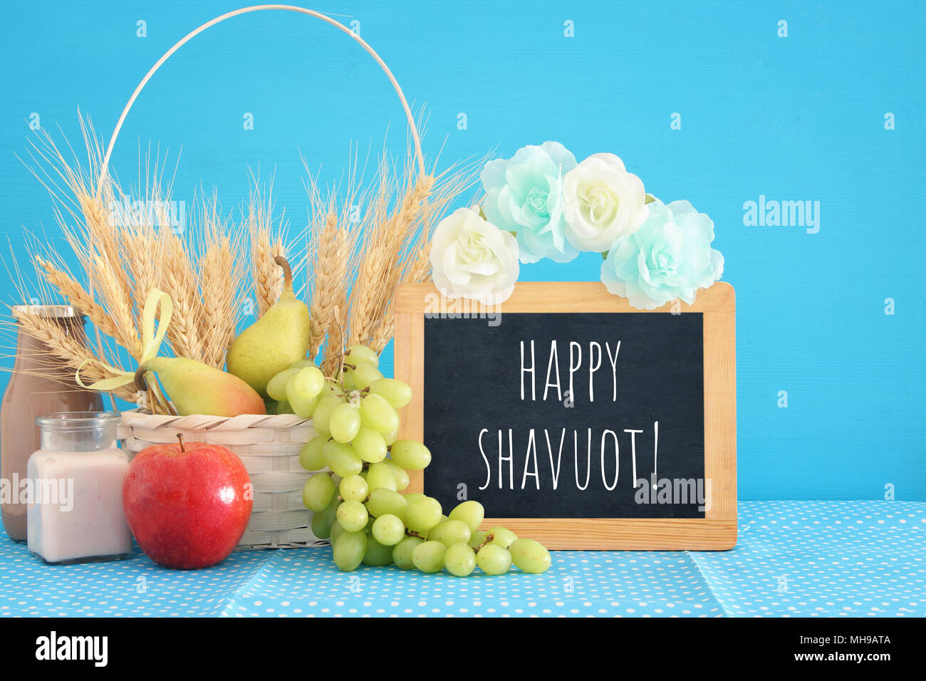 image of dairy products and fruits over wooden table. Symbols of jewish ...