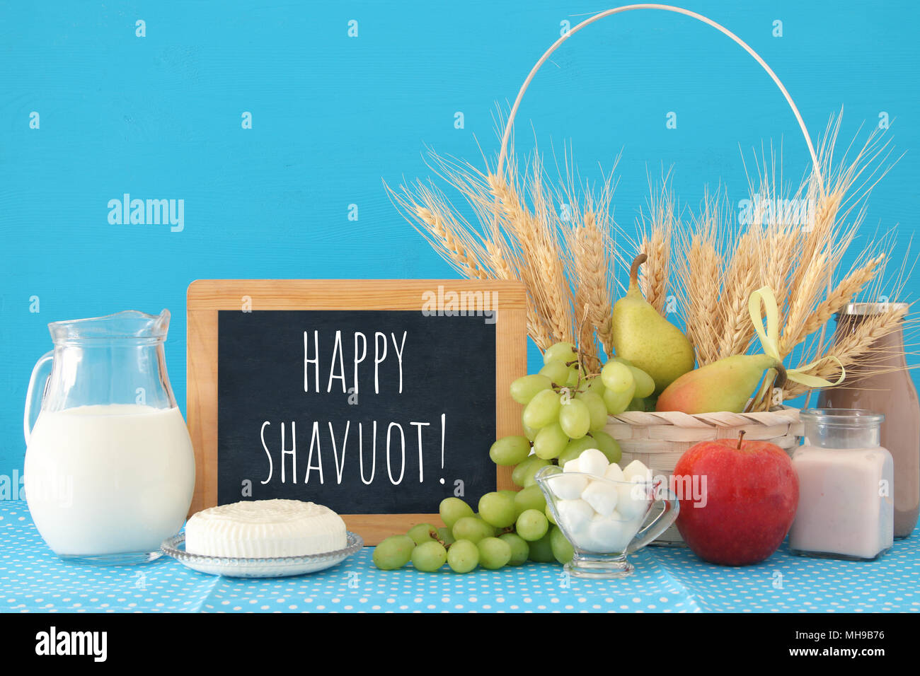 image of dairy products and fruits over wooden table. Symbols of jewish ...