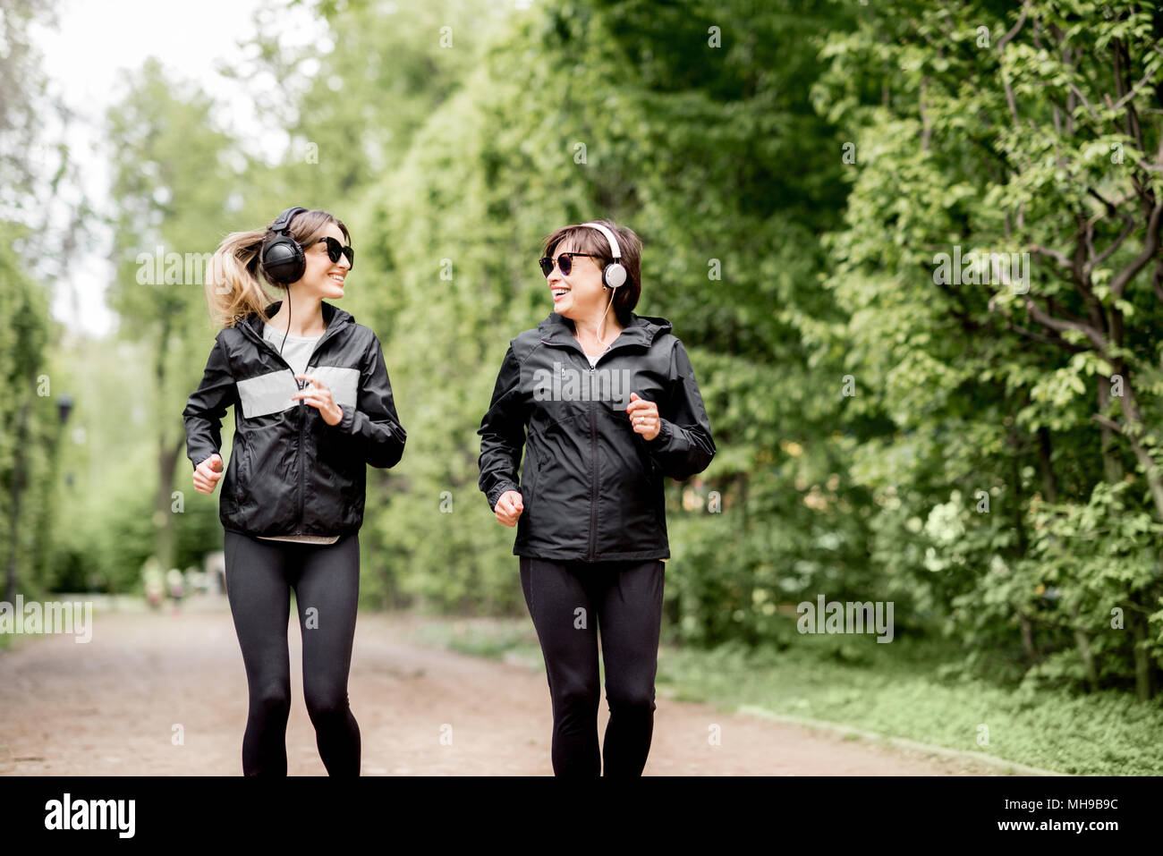 Two women running in the park Stock Photo - Alamy