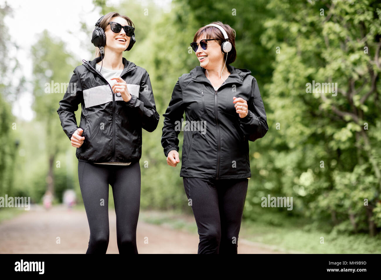 Two women running in the park Stock Photo - Alamy