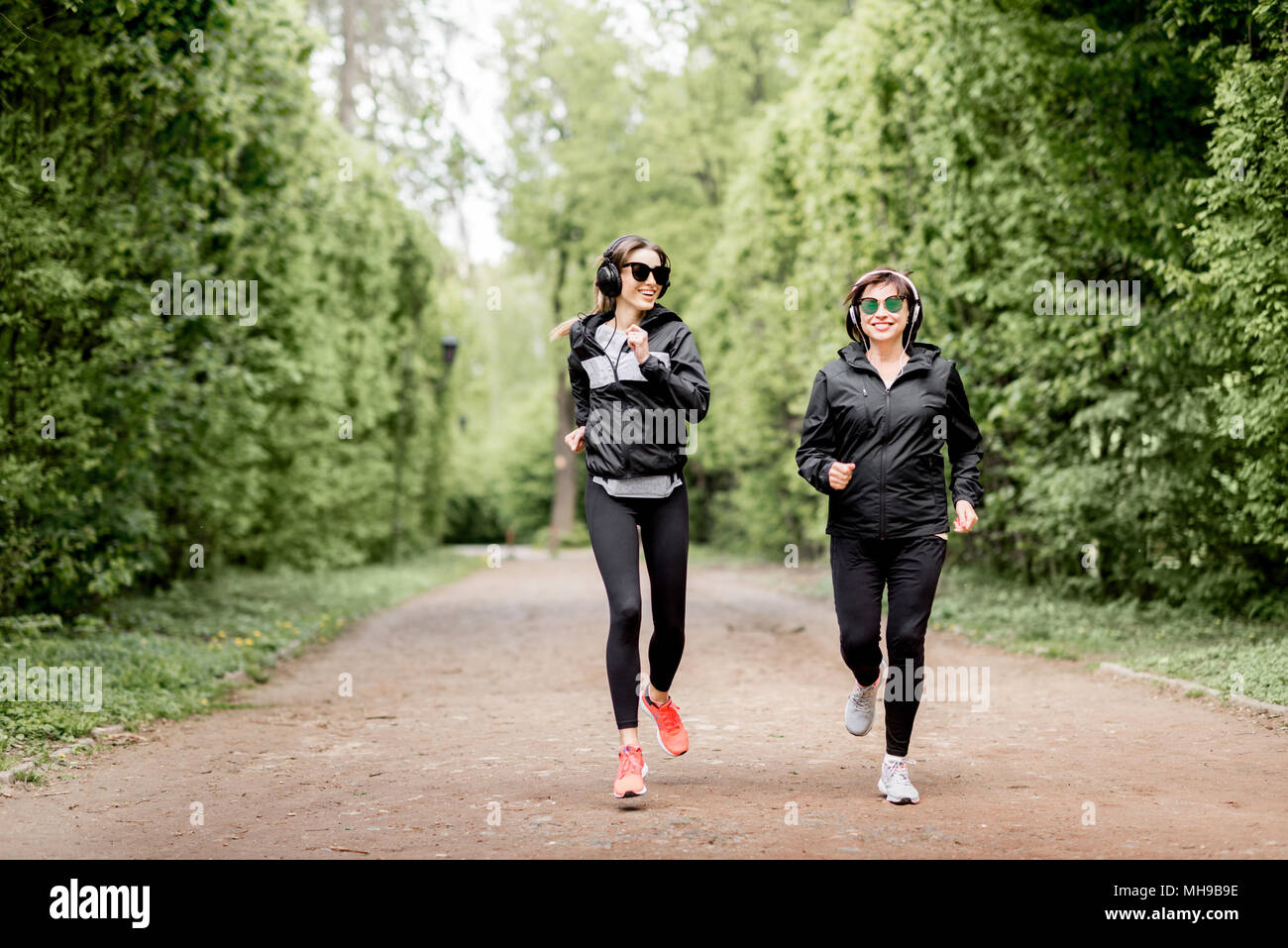 Two women running in hi-res stock photography and images - Alamy