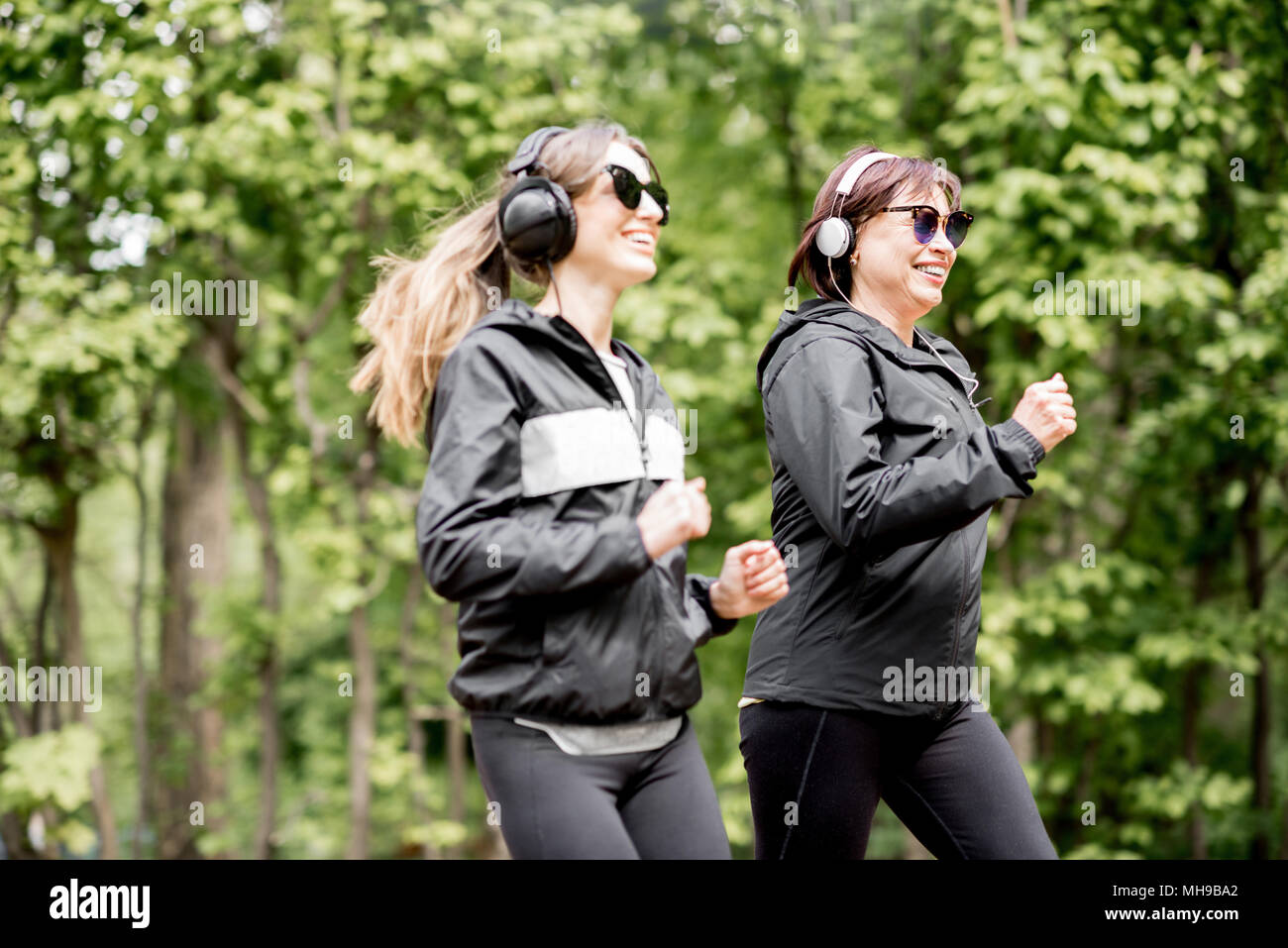 Two women running in the park Stock Photo - Alamy