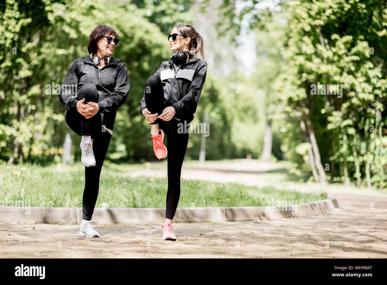 Two woman exercising in the park Stock Photo - Alamy