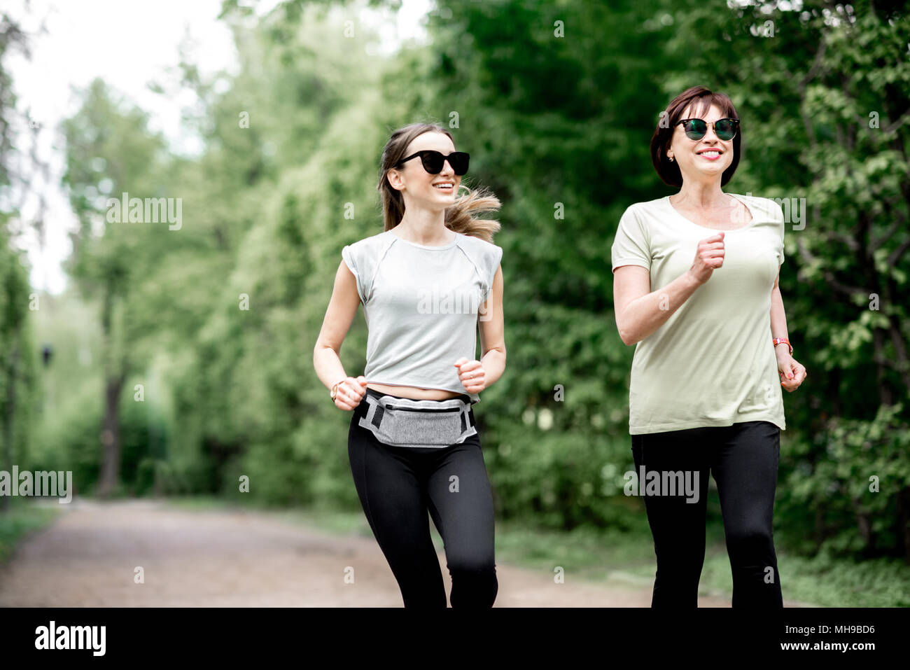 Women running together park hi-res stock photography and images - Alamy
