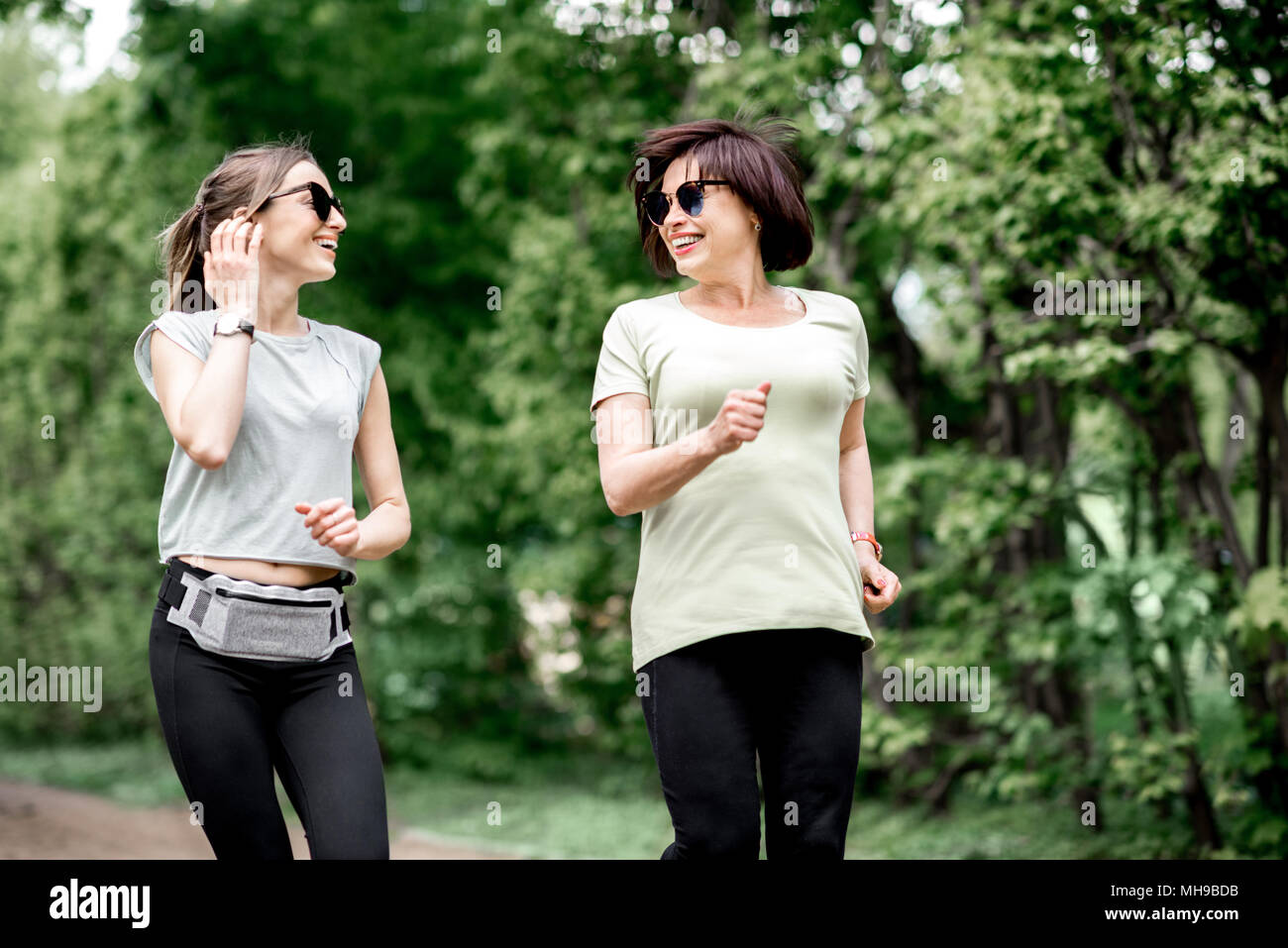 Women running together park hi-res stock photography and images - Alamy