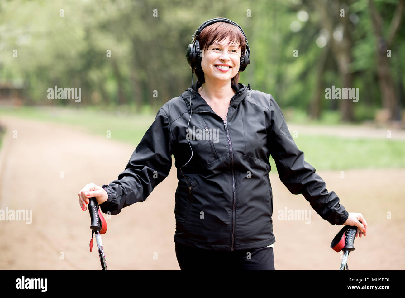 Old woman walking stick park hi-res stock photography and images - Alamy