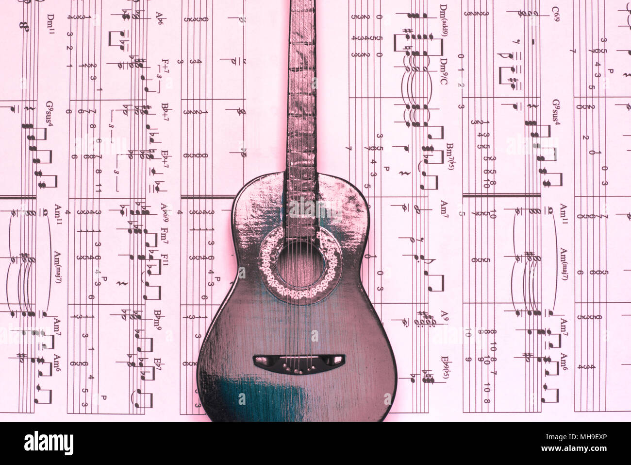 A guitar resting on the notes Stock Photo - Alamy