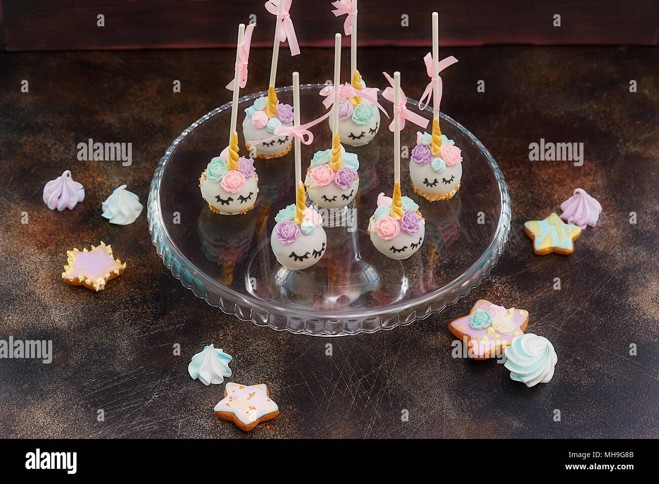 Colorful sweet cake pops with faces on dark wooden background Stock ...