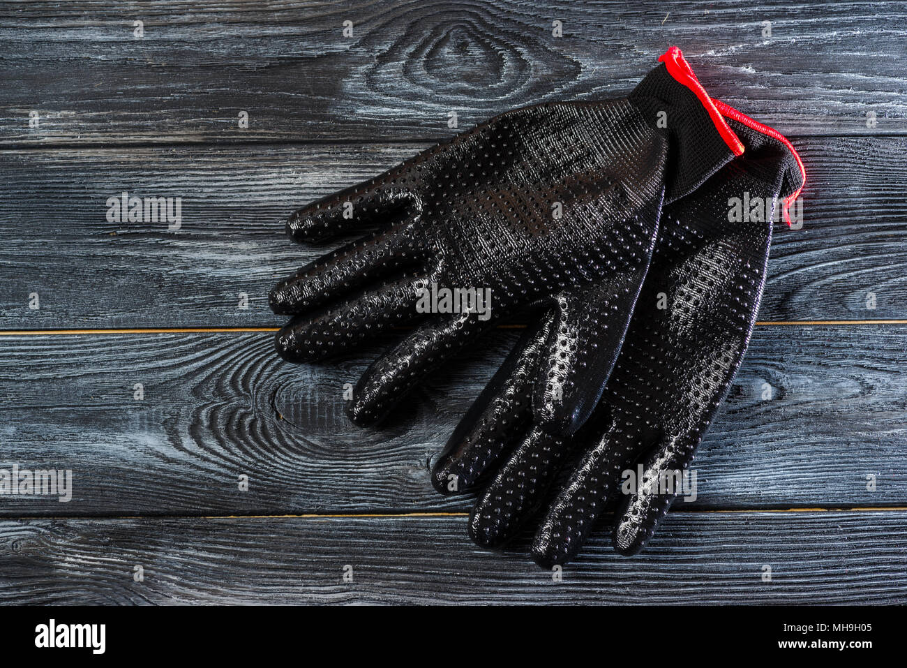 black rubberized gloves for work Stock Photo - Alamy