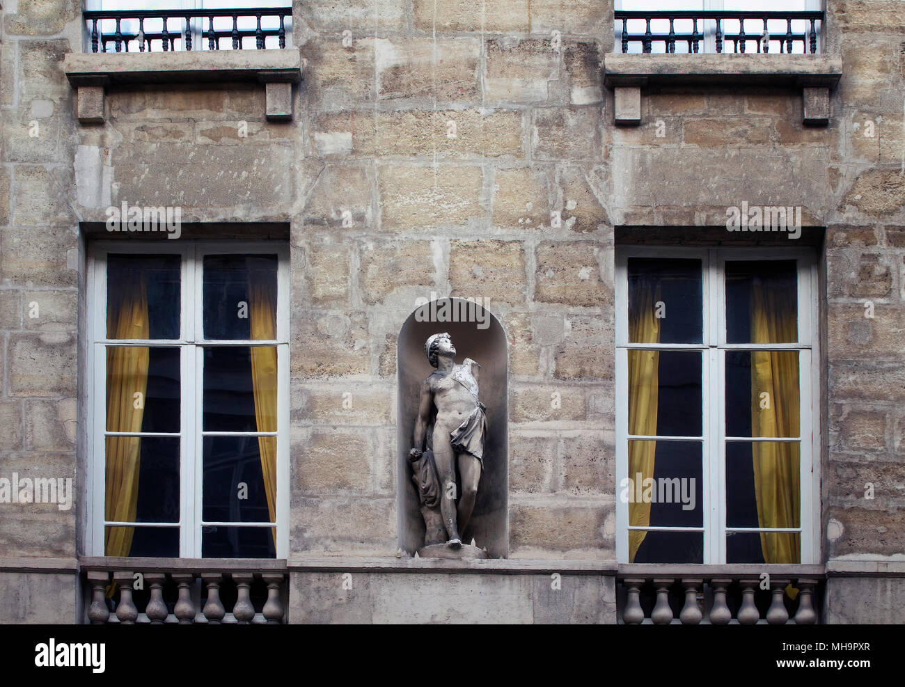 View of a statue / sculpture placed on the facade of a building in ...