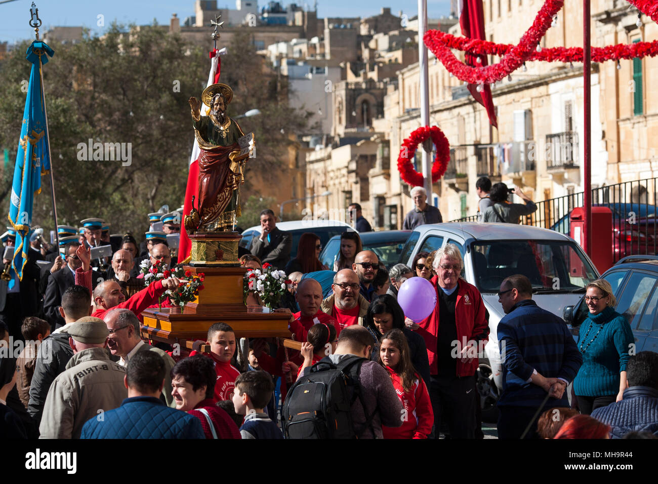 A parade carrying the celebrated saint pases through the streets of ...