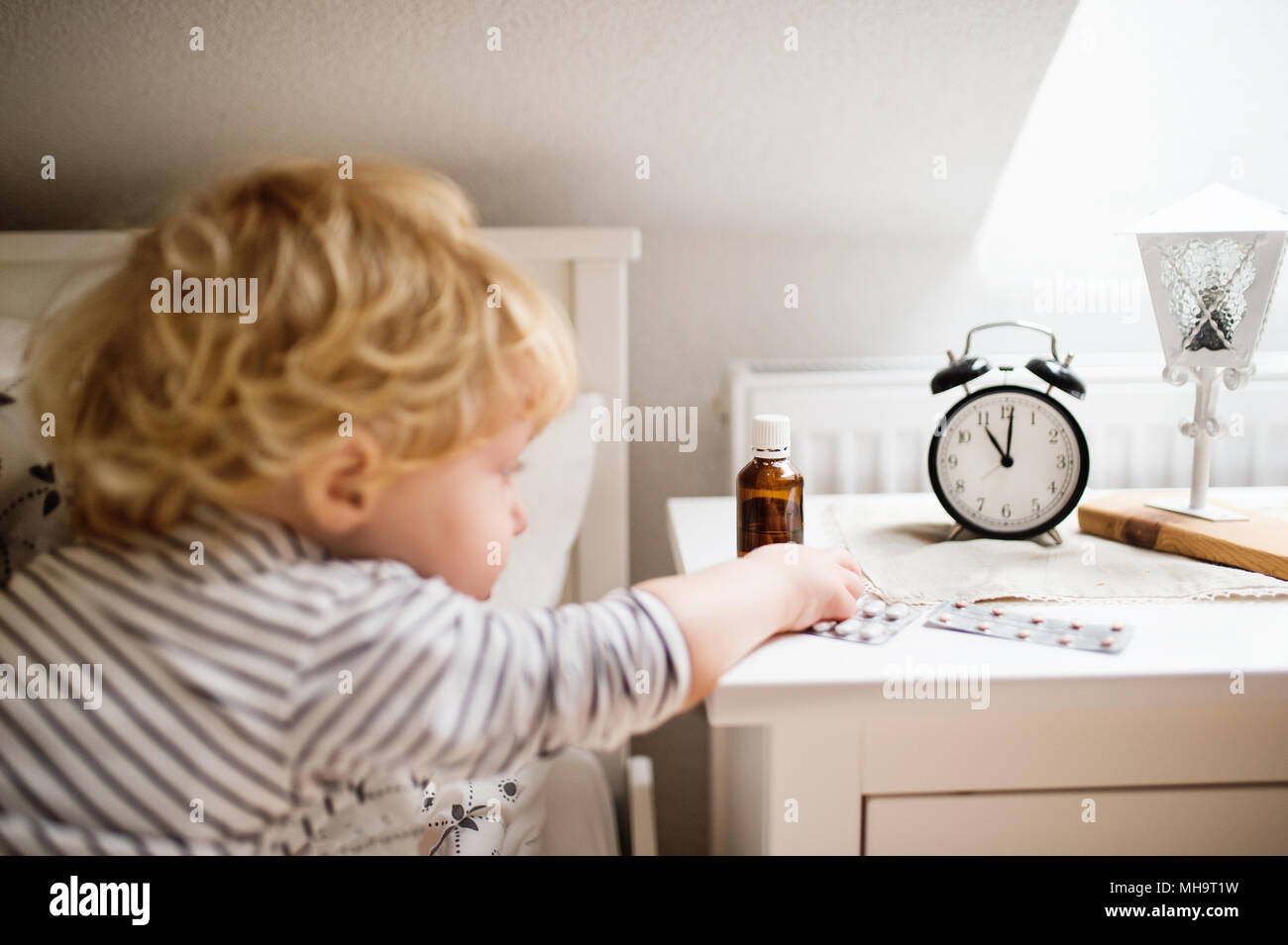 Toddler boy in a dangerous situation at home Stock Photo - Alamy