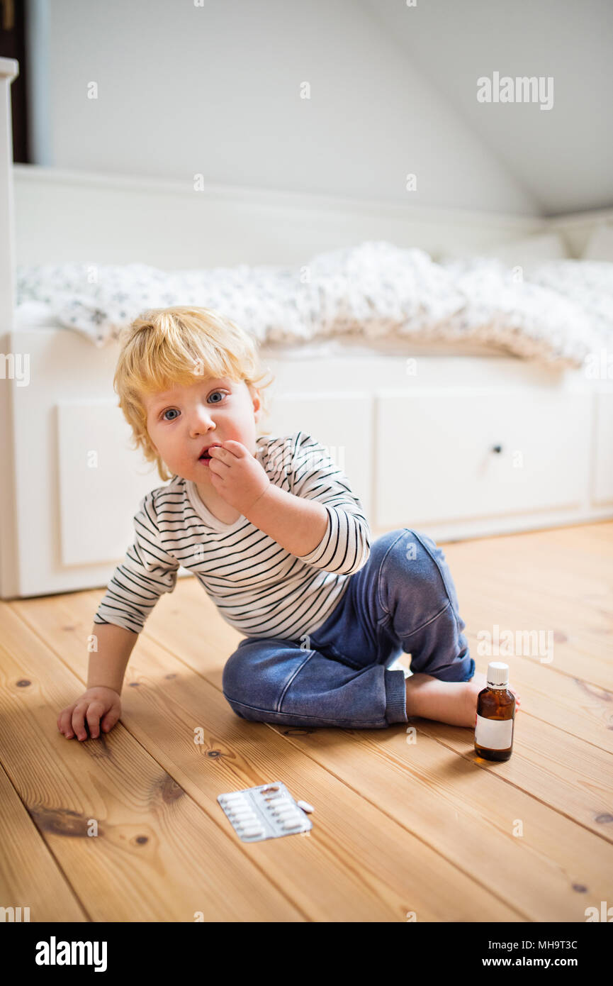 Toddler boy in a dangerous situation at home Stock Photo - Alamy