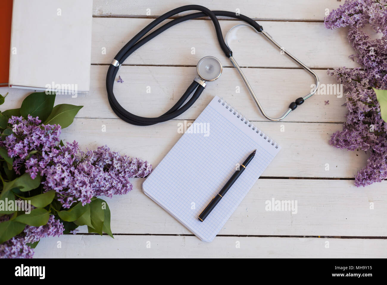 on the table lay a lilac, stethoscope, notebook Stock Photo - Alamy