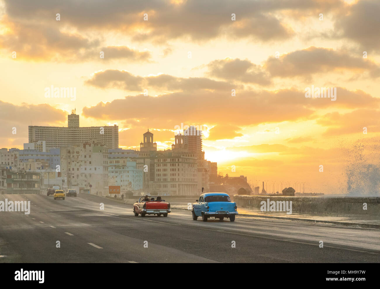 The sun sets as classic cars travel along the Malecon in Havana, Cuba ...