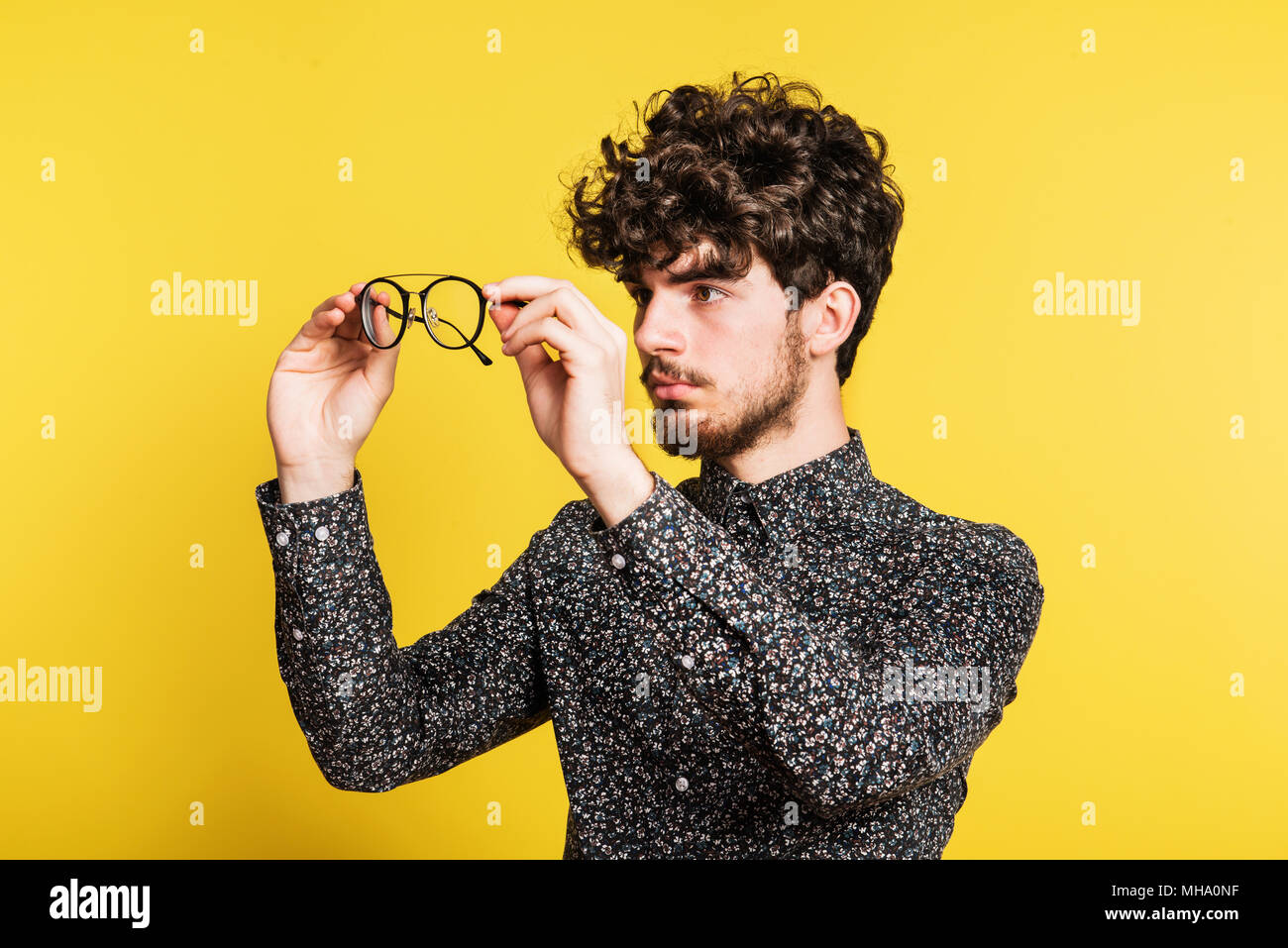 Studio portrait of a young man on a yellow background Stock Photo - Alamy