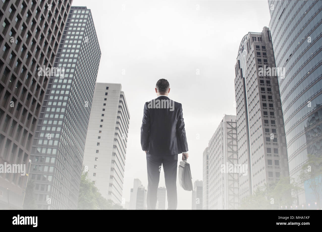 Businessman looking across the city financial district concept for ...
