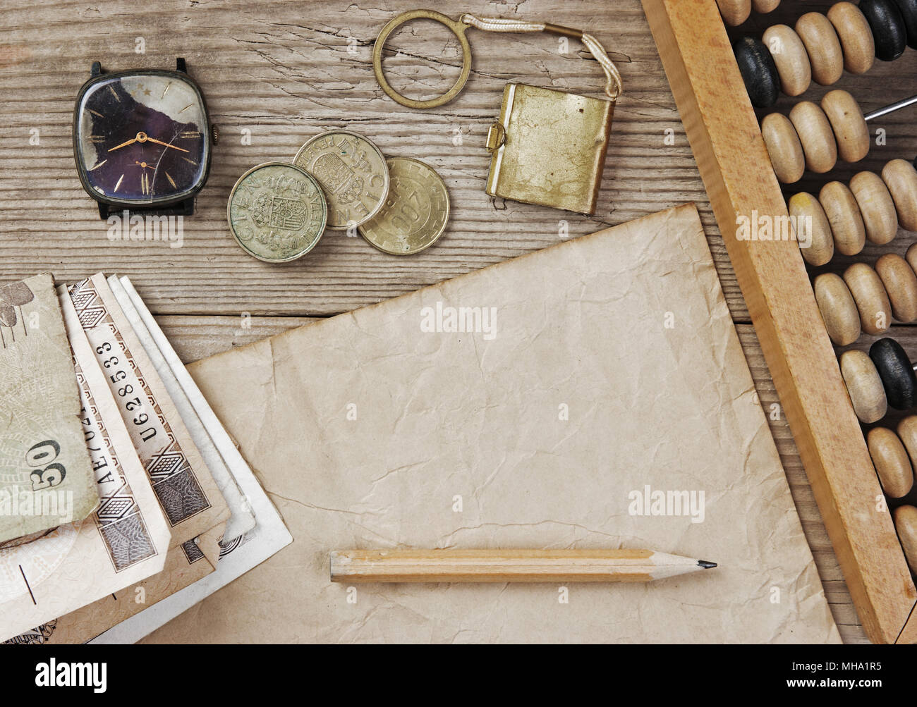 Old notes and coins and abacus on a wooden table Stock Photo - Alamy