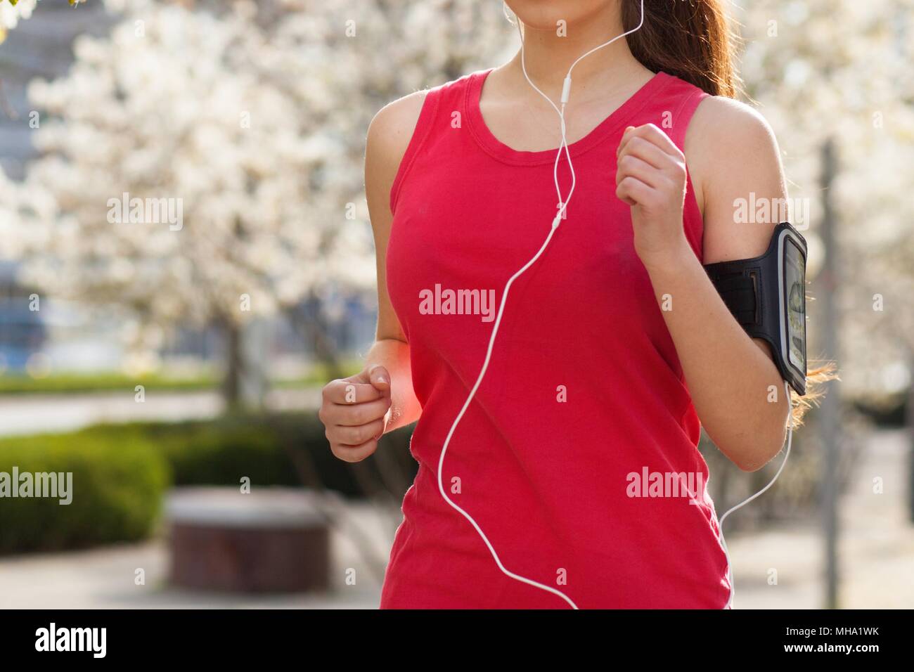 Woman running with headphones hi-res stock photography and images - Alamy