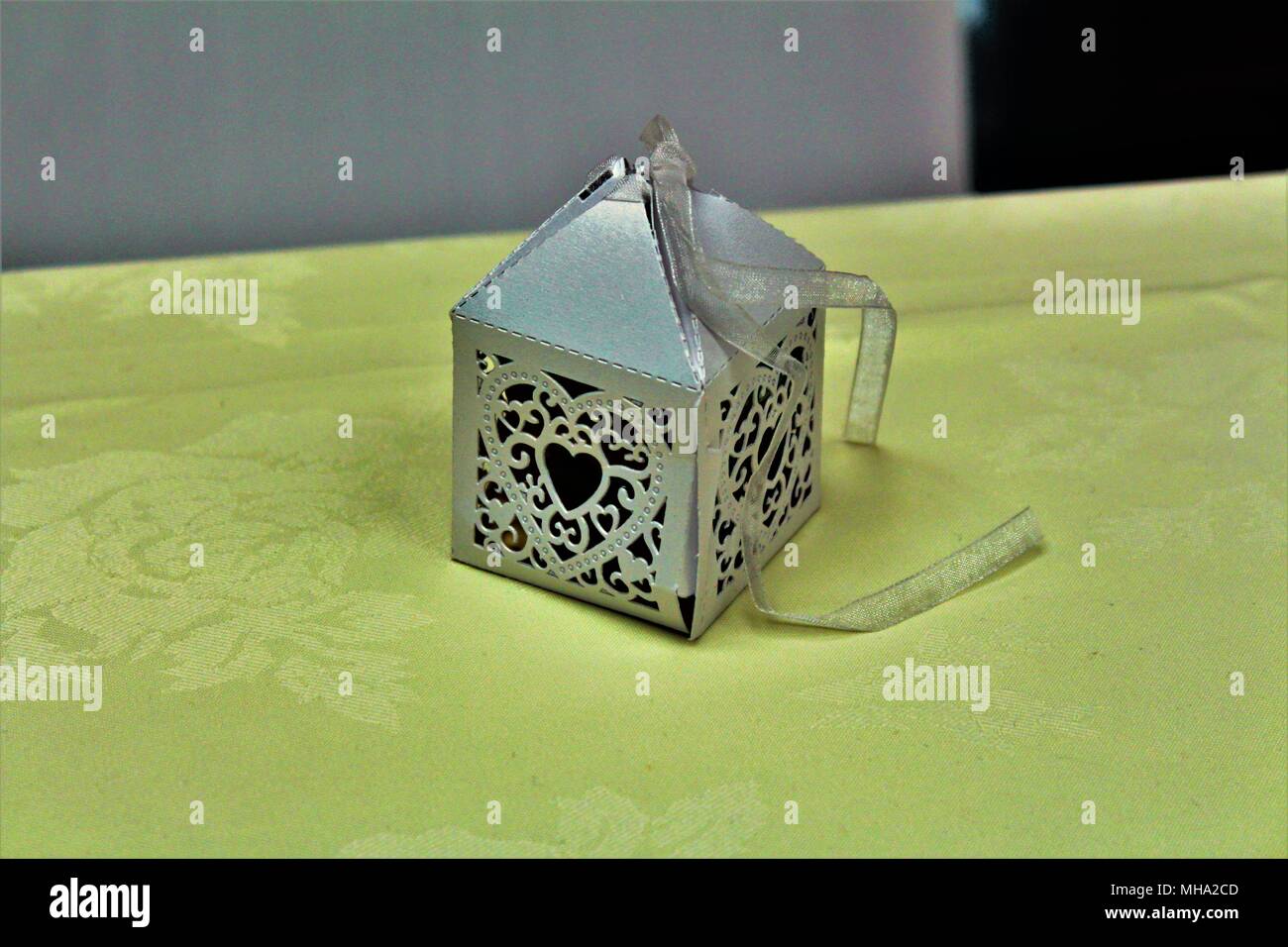 A close-up of an individual sweet candy gift box for a guest at a ...