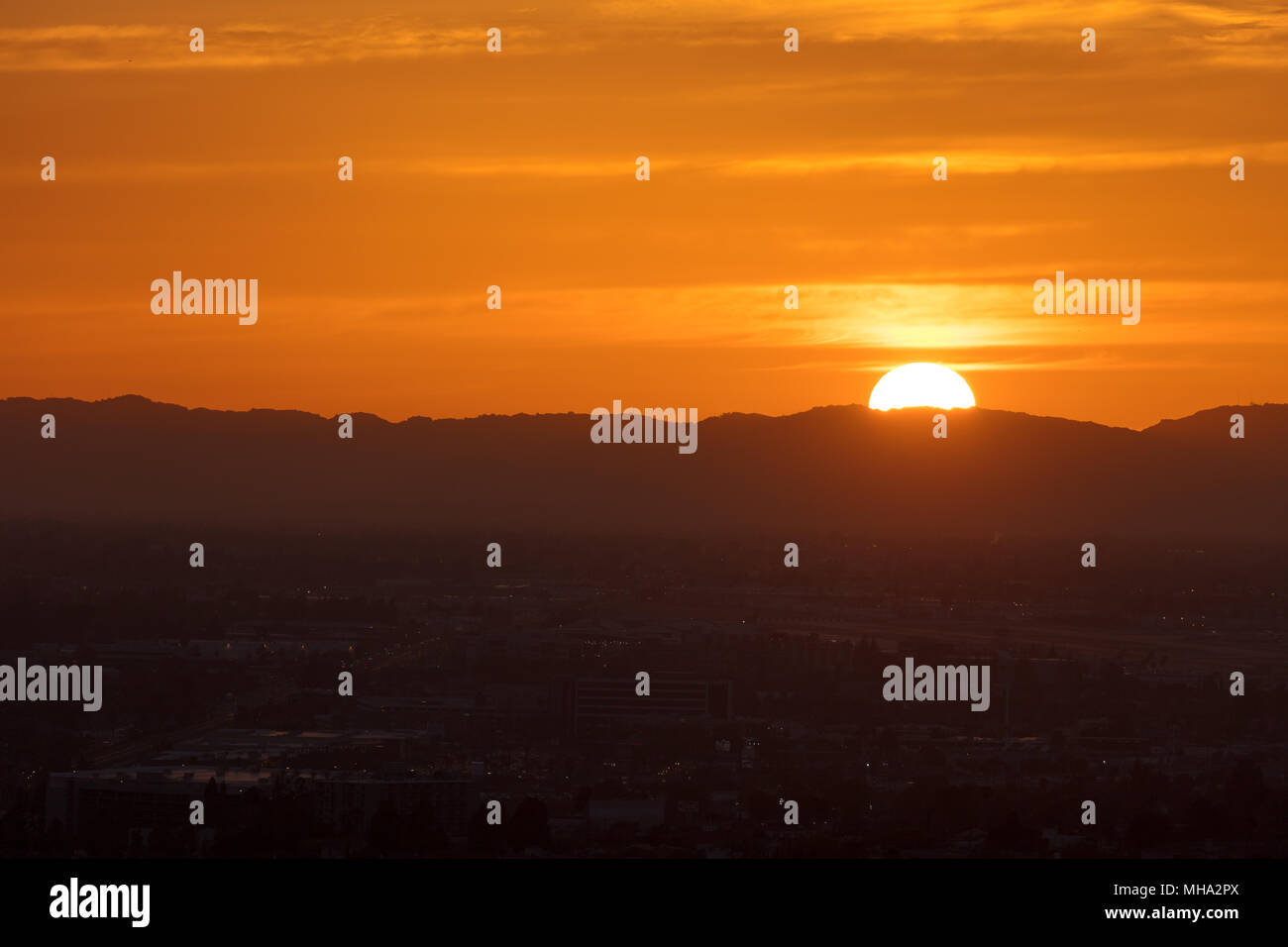Sun halfway set Stock Photo - Alamy
